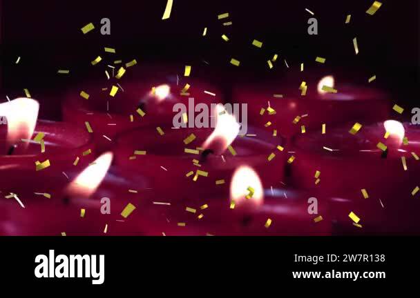 Animation of gold confetti falling over lit red candles on black ...