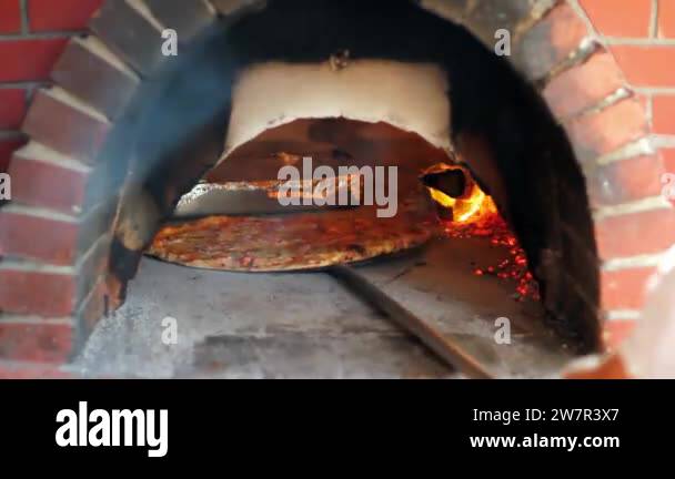 Pizza Chef Cooking Pizza in a Wood Fired Brick Oven. Pizza Baking in Traditional Pizza Oven with ...