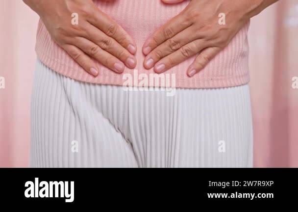Young sick woman with hands holding her belly suffering menstrual ...