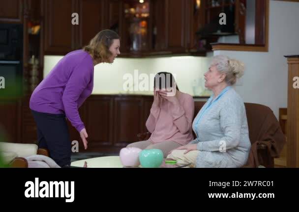Angry mother and grandmother arguing yelling gesturing as upset ...