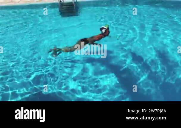 25.05.2021 Cyprus Paphos beautiful young woman swimming in pool and ...