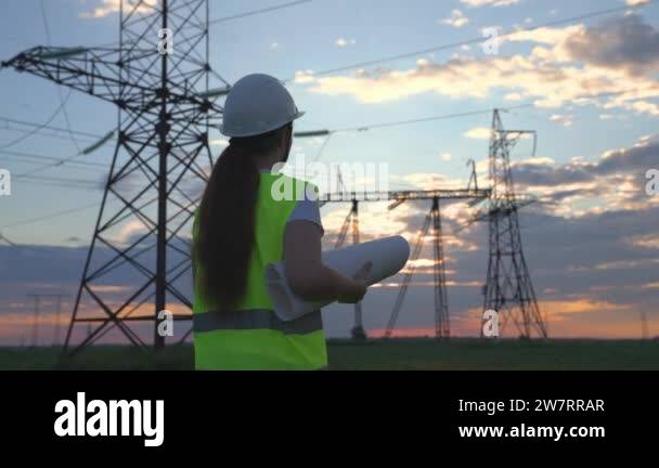 an electrical engineer at a power plant of high towers checks the ...