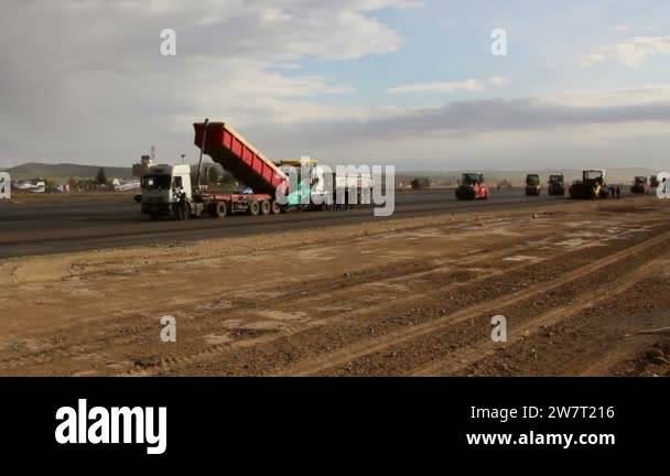 Tracked paver laying fresh asphalt pavement,time lapse Stock Video ...