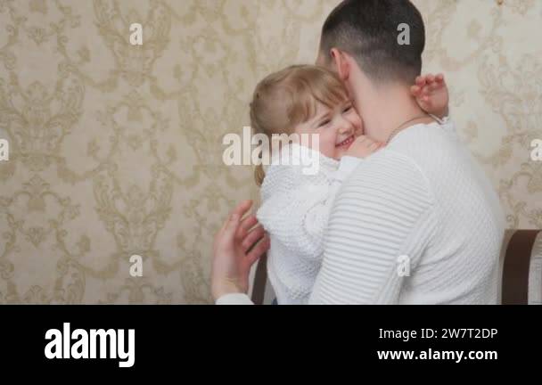 Adorable little daughter hugging her father at home. Happy family ...
