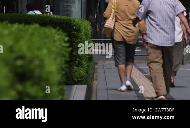 A slow motion of body parts of walking people at urban city in Tokyo ...