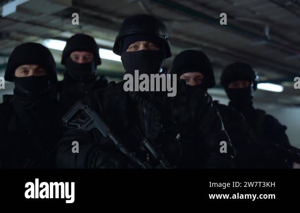 SWAT police officers posing at camera. Police special forces holding ...