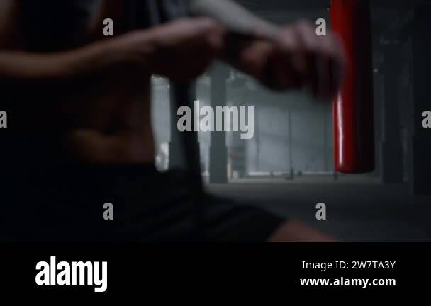 Fighter wrapping hands with boxing tapes in gym. Afro guy using ...