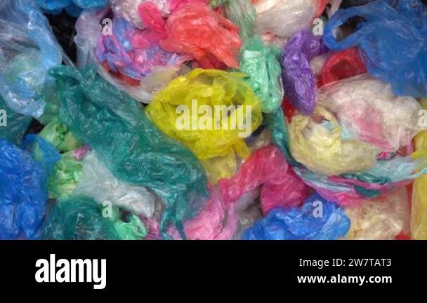 A lot of Colorful Single-use Plastic Shopping Bags throw away form a ...