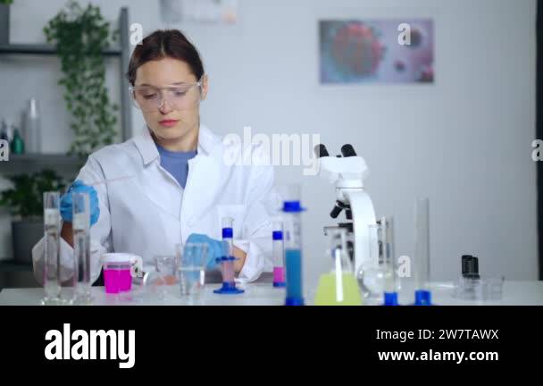 microbiological investigation in laboratory, woman employee is viewing ...