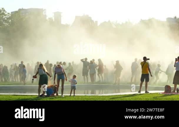 powder paints. silhouettes of people. back view. crowd of people having ...