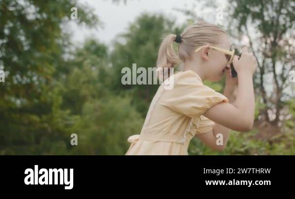 girl child take pictures in the park outdoors kids dream concept happy ...