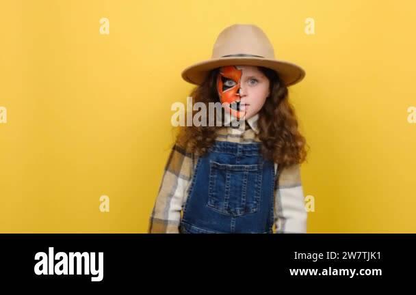 Portrait of scared little girl kid with Halloween makeup mask wear ...