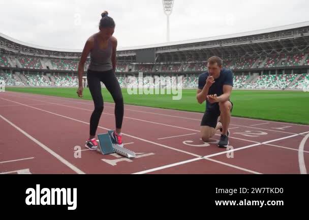 Slow motion, young female sprinter are training at the stadium, african ...