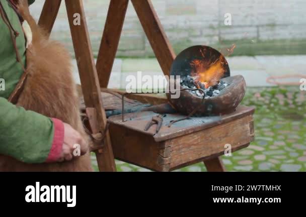 ancient forge and blacksmith sinks the bugle in the manual medieval ...
