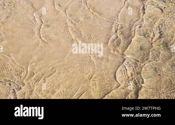 Beautiful shallow water flows with sun reflections. The surface of a ...