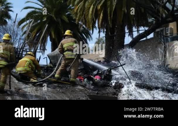 Los Angeles, CA USA - March 26, 2021: Fireman extinguishing a fire at a ...