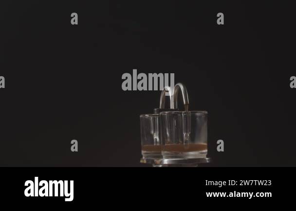 Heat vapor emitted from the coffee machine. Two glass coffee cups on a ...