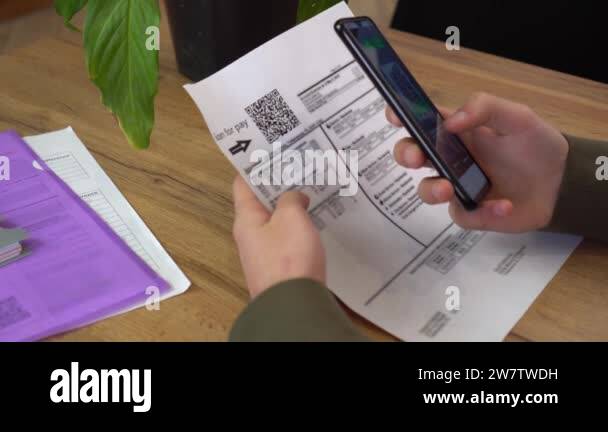 QR Utility Bill. Mobile Bill Payment with QR Codes. A woman scanning ...