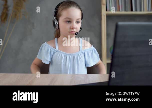 a sad girl sits at a computer laptop, suffering from cyberbullying and ...