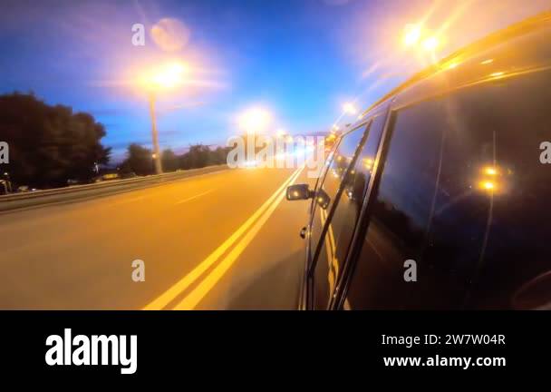 Black suv driving on city highway at night. Auto riding through town ...