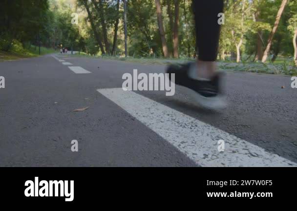 Close-up of female legs run in park outdoors. Unrecognizable slim ...