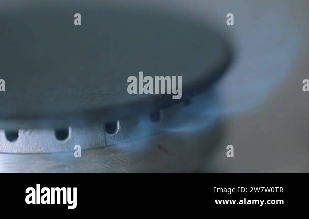 The fire is ignited on the gas stove. Gas burner close-up. Gas stove ...