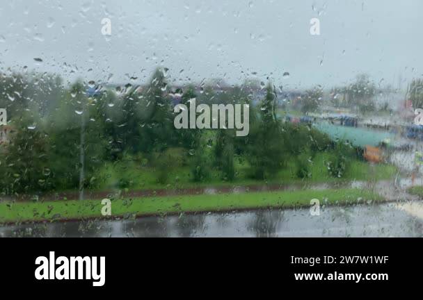 Rainy day through the window on sky and city buildings background Stock ...