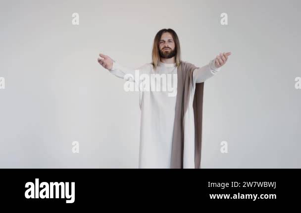 Jesus in robe spreads his hands to the sides calling for prayer. Studio ...