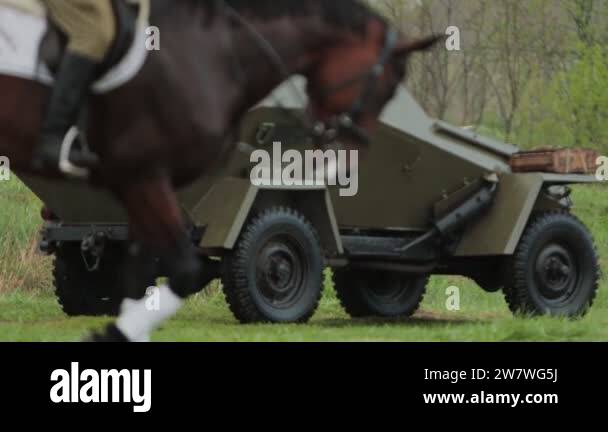 Red Army soviet armored car and rider on horse ride on field during ...