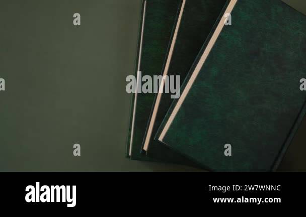 Reading of books. Books stack with green covers on dark green ...