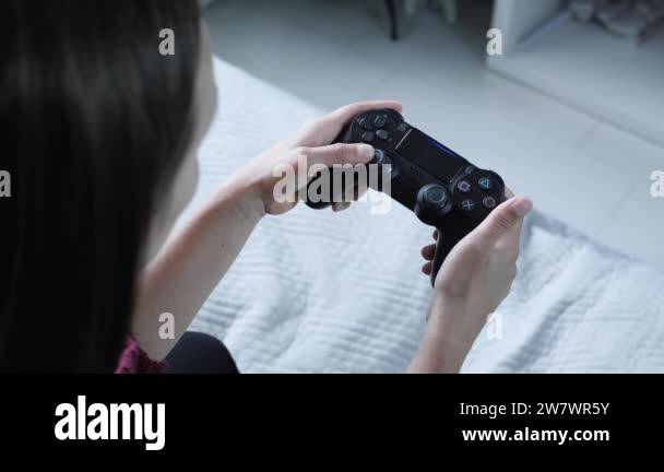 Hands use joystick in electronic game. Girl playing video games with ...