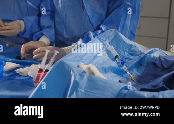 Vascular surgery. Radiologist performs endovascular operation with ...