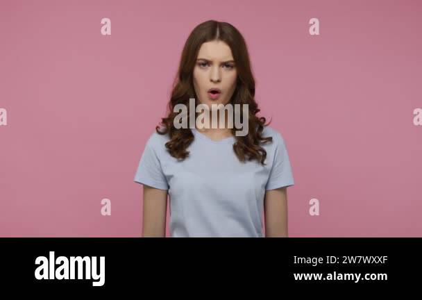 Don't show me! Scared teenager girl with dark wavy hair in T-shirt ...
