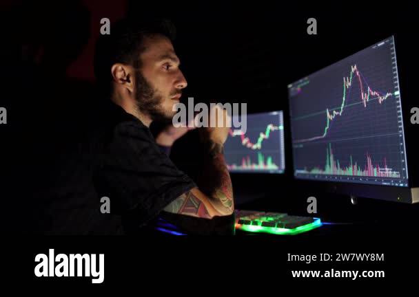 Stock Market Trader Looking At Graphs And Analyzing Them On Multiple
