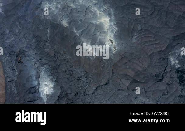 Aerial birds eye overhead top down panning view of warm solidified lava ...