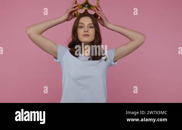 Selfish wavy haired teenager girl wearing golden crown, proud of her ...