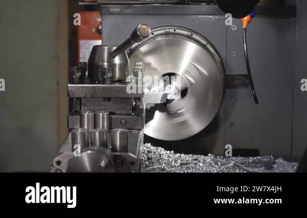 Metalworking plant.Workers at the machines process the parts.CNC ...