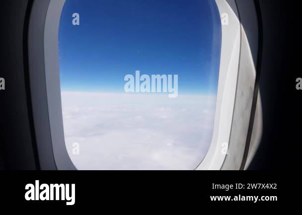 The hand opens and closes the plane window to look out during air ...