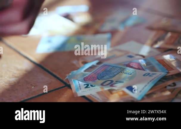 Unrecognisable person gathering euro banknotes from the floor, person ...