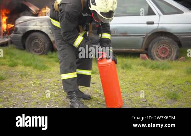 On the Car Crash Traffic Accident Scene: A fire rescue worker quickly ...