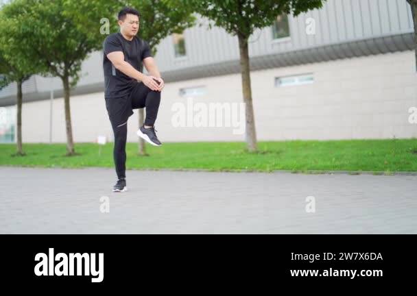 young asian runner athlete with muscle pain. Man massaging Stretching ...