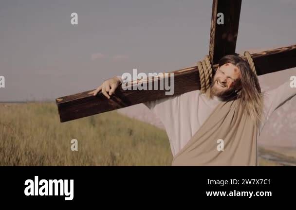 Jesus carries the cross on his back. walks on the grass, background of hills Stock Video Footage ...