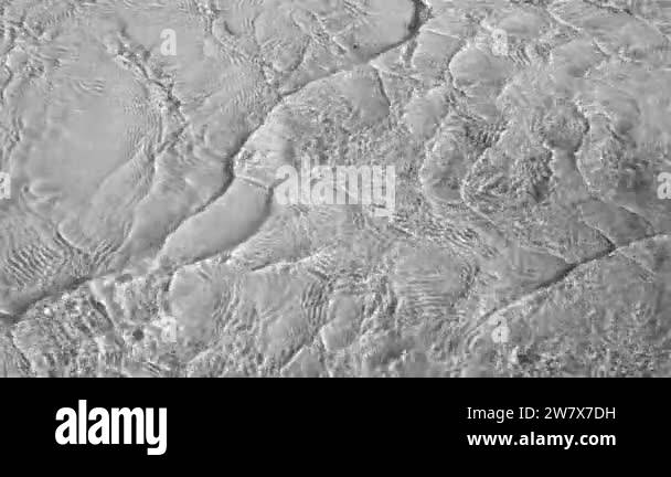 Beautiful shallow water flows with sun reflections The surface of a ...