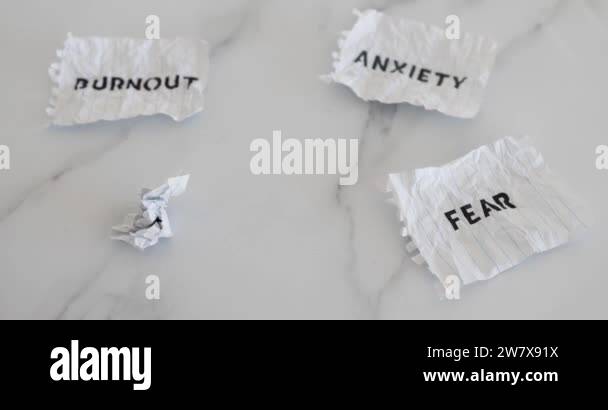 Fear Anxiety Stress and Burnout words on pages getting scrunched up and ...