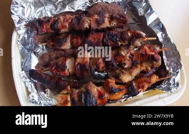 Grilled meat in disposable packaging and aluminum foil, delivered from ...