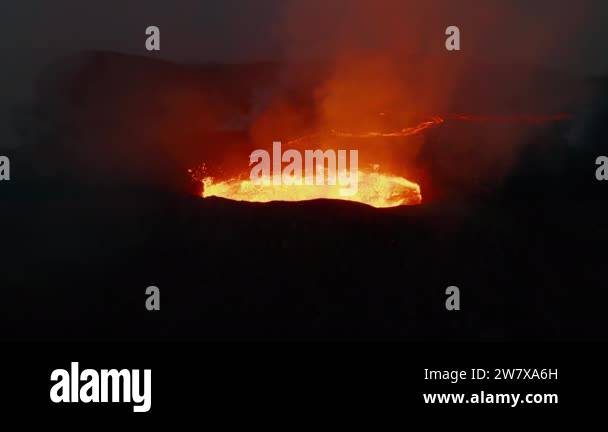 Orbit shot around volcano crater eruption. Close-up of boiling magmatic ...