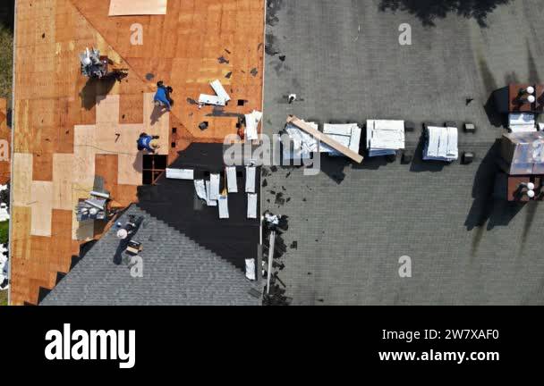 Removal of old roof and replacement with new roof shingle being applied ...
