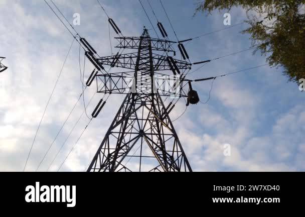 metal structures of power lines under blue sky and white floating ...