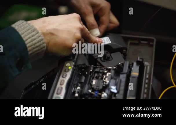 Worker welds optical line internet wire with welding machine. Service ...
