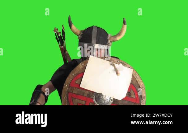 Portrait of mature Viking warrior raised shield with leaf attached with ...